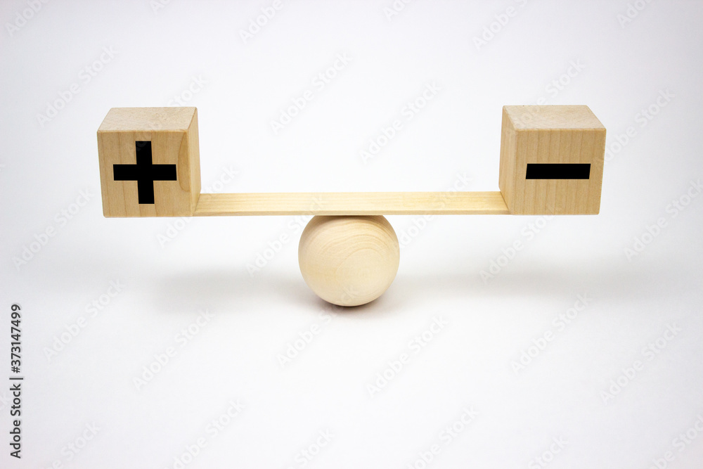 Plus And Minus Or Positive And Negative Symbols On Wooden Blocks Are In