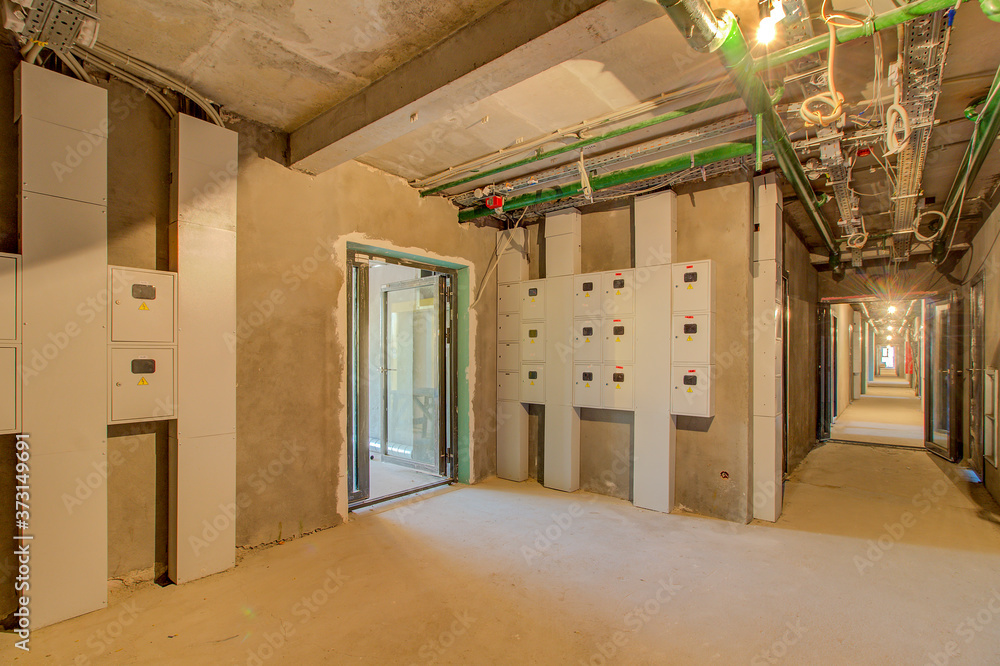 Electrical panel on wall. construction long light corridor in ...