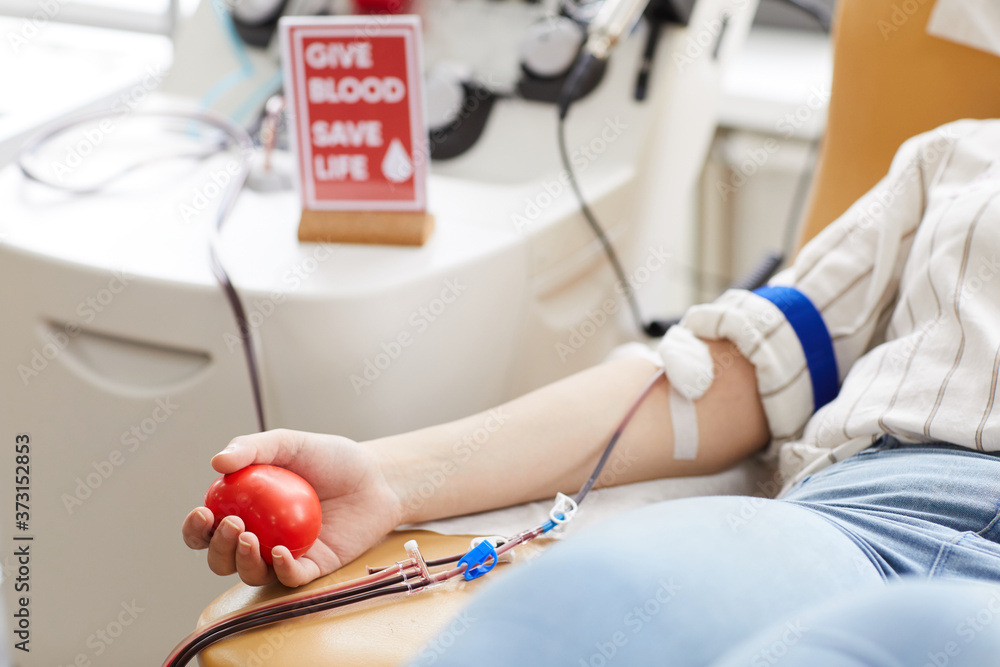 Close-up of female donor with ball in her hand and in catheter in her ...