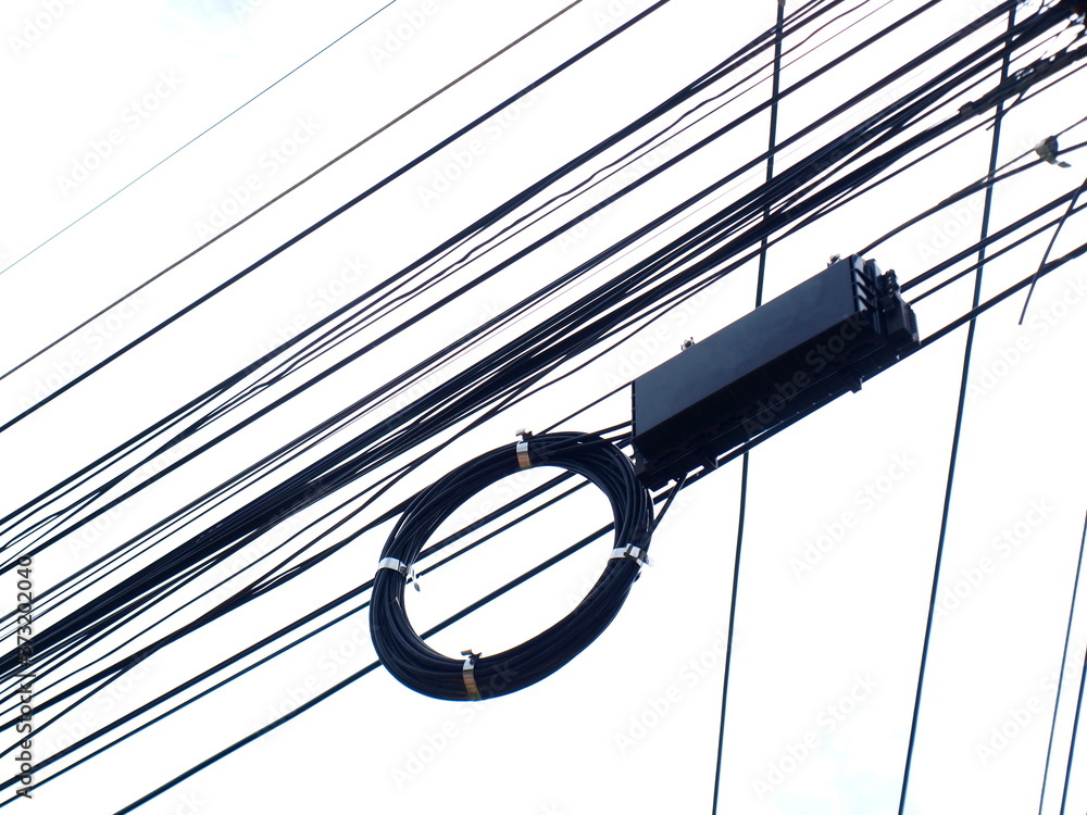Black plastic box of Fiber Optic Internet. With cable reels hanging on ...