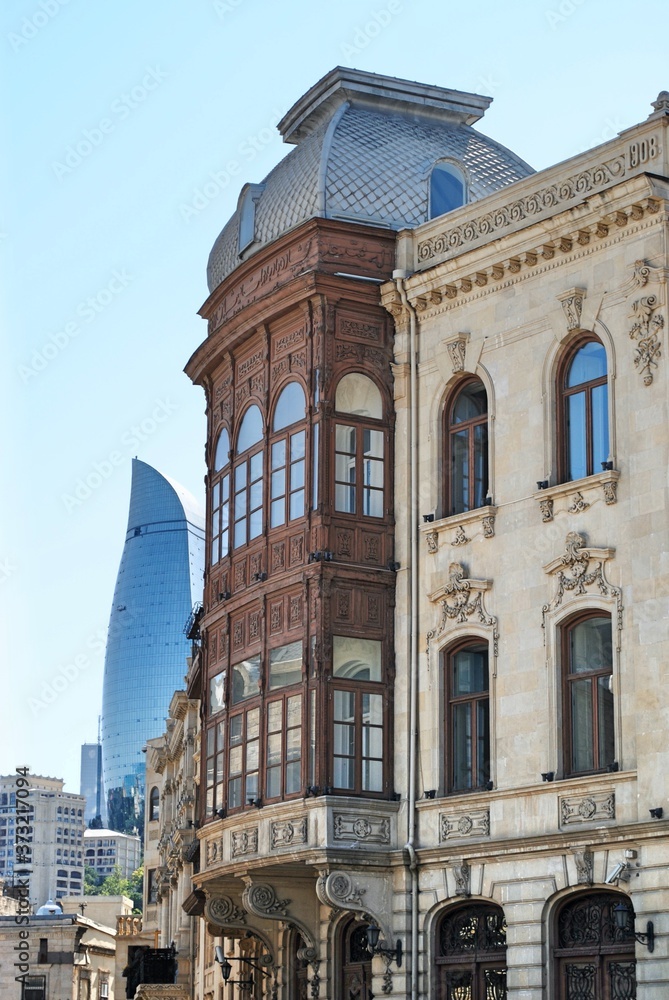 The Old City classic buildings in Baku with modern Flame Towers ...
