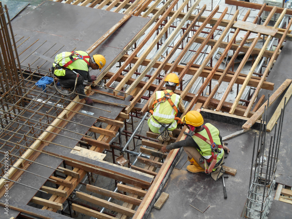 KUALA LUMPUR, MALAYSIA -MARCH 05, 2020: Construction workers installing & fabricating timber ...