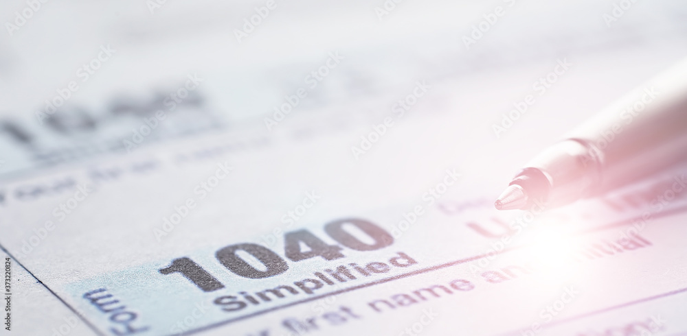 Annual tax reporting. Tax form on the table. Financial statements for ...