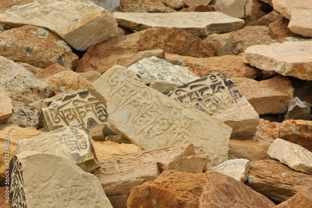 Mani stones with mantra "Om mani padme hum" Stock Photo | Adobe Stock