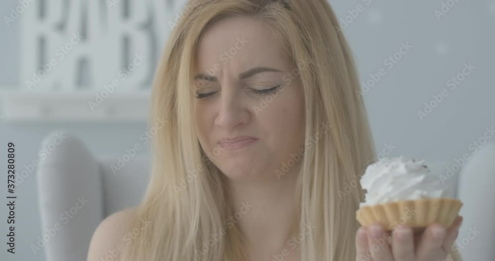 Close-up portrait of gorgeous pregnant woman tasting cream and making ...