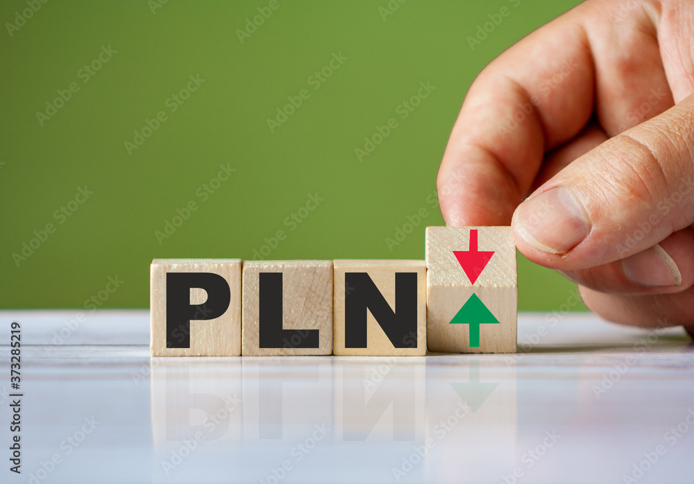 Word PLN currency symbol concept and hand turn wooden block and change ...