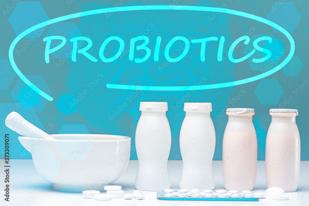 Logo probiotics on biologist desk. Plate for grinding tablets. Bottles ...