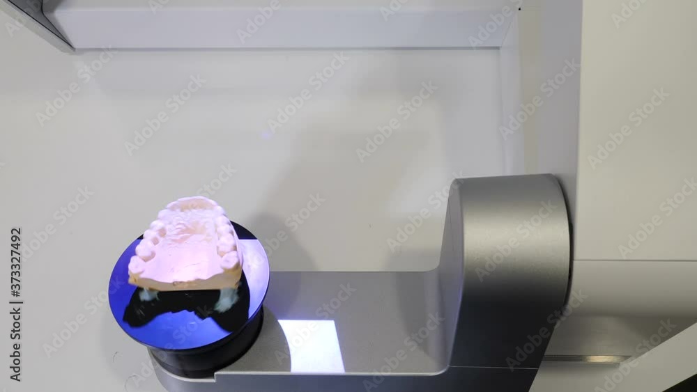 Dental prosthetic restoration. Bright laser moving on surface of gypsum ...