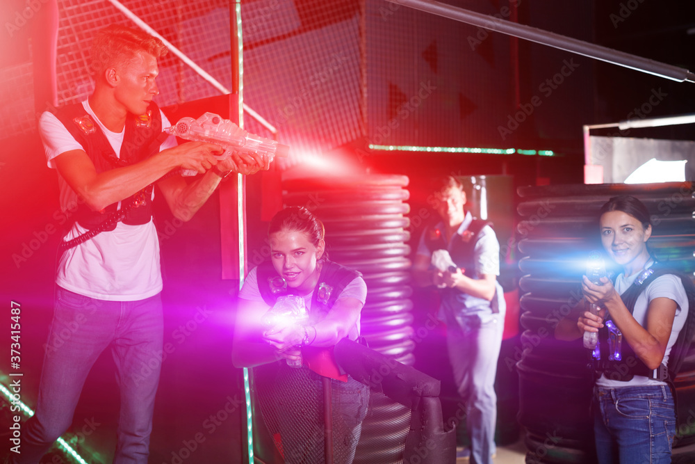 Pretty young girls took aim with colored laser guns during laser tag ...