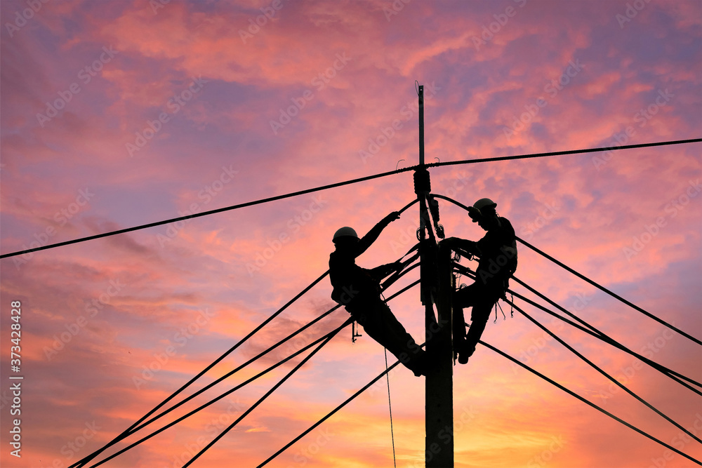 Electrician worker climbing electric power pole to repair the damaged ...