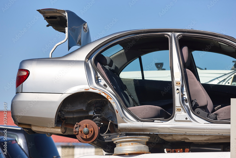 Car scrapyard. Stacked damaged vehicles ready to be recycling ...