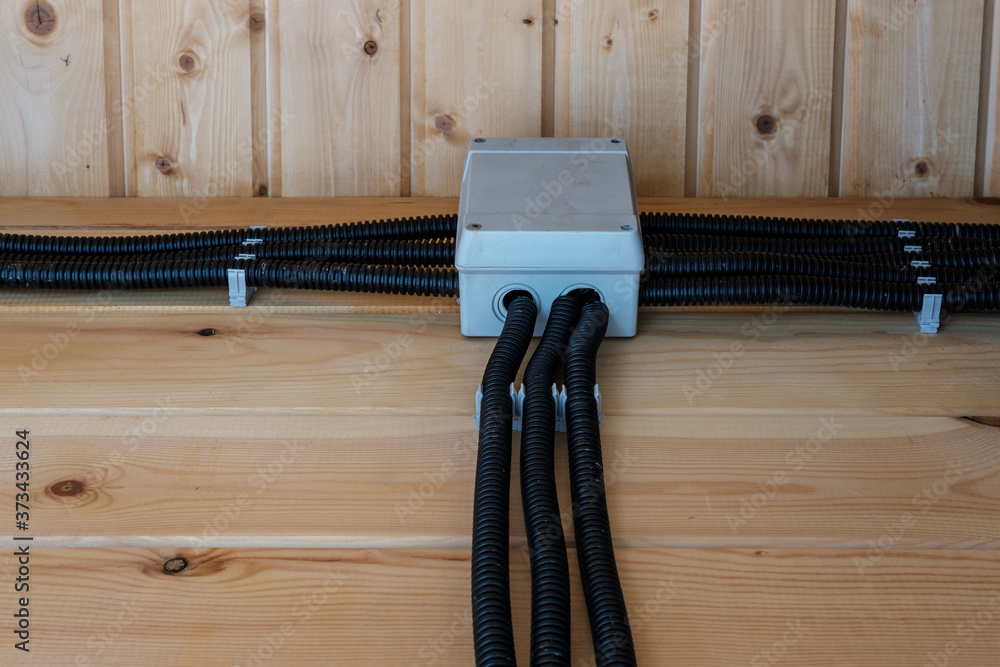 Open electrical wiring in the house, hidden in an insulating ...