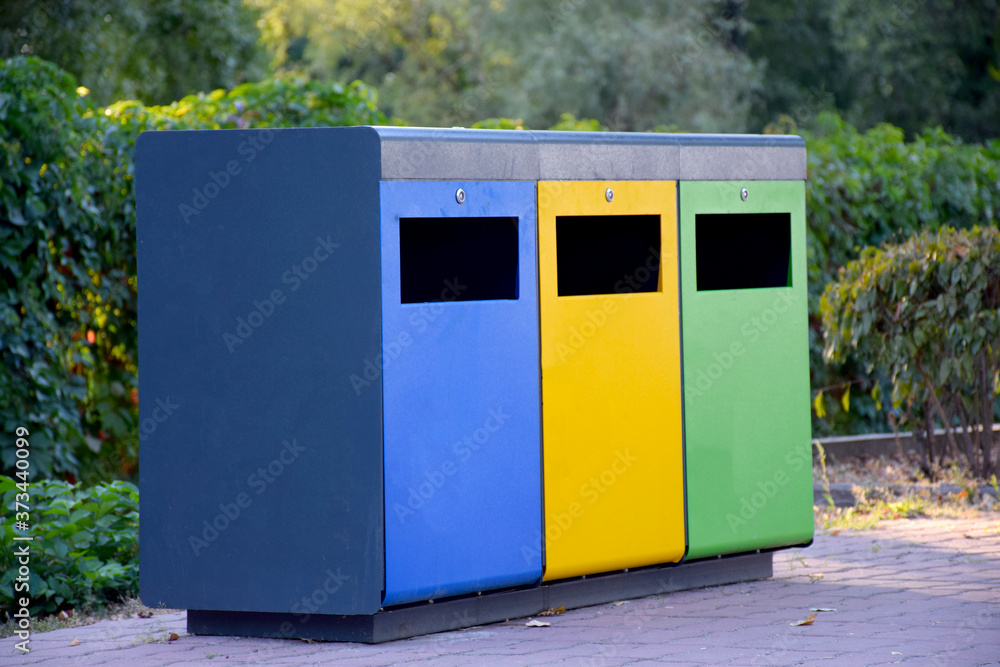Three different garbage container for sorting waste in the city. Yellow ...