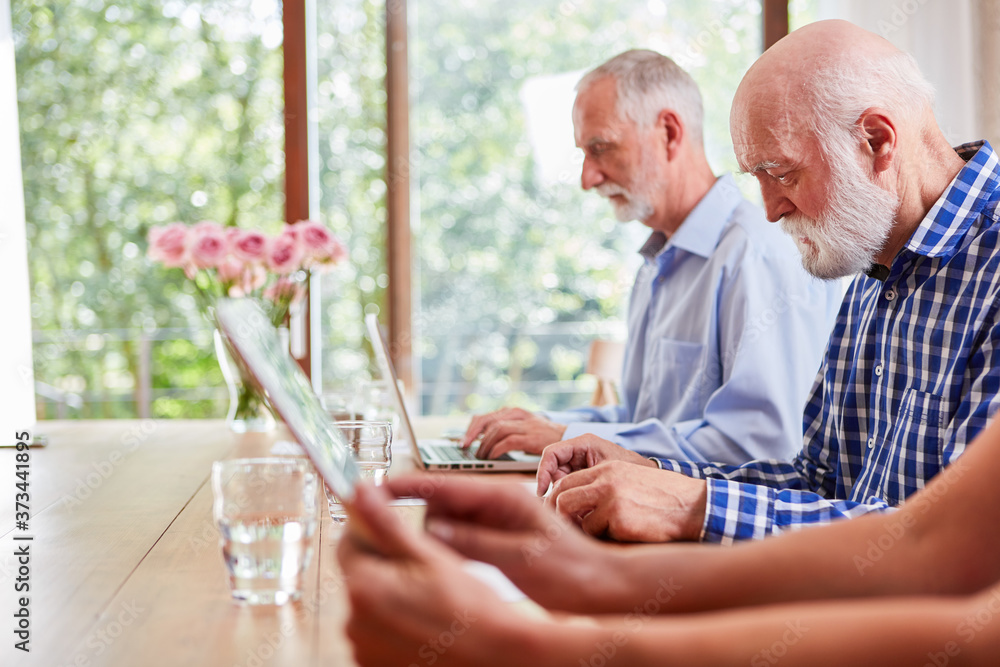 Group of seniors with laptop in computer class Stock Photo | Adobe Stock