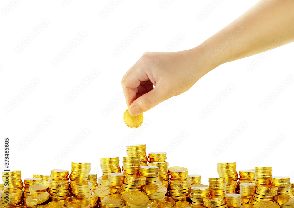 Gold coin in hand with many gold coin pile isolated on white background ...