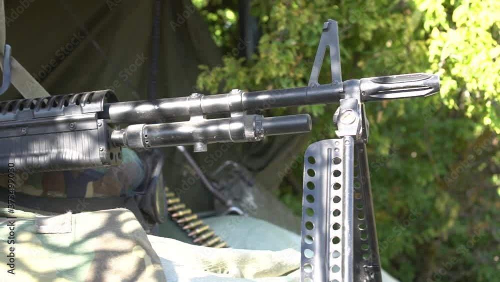 Soldier tracks target, front view. Soldier prepares to shoot a machine ...