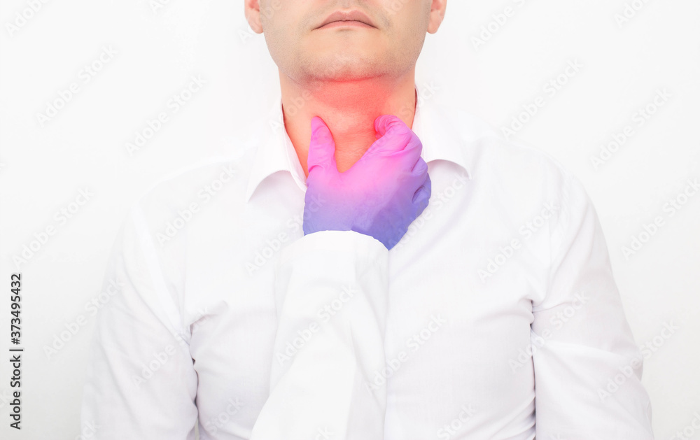 The doctor checks during the examination of the thyroid gland in a man ...