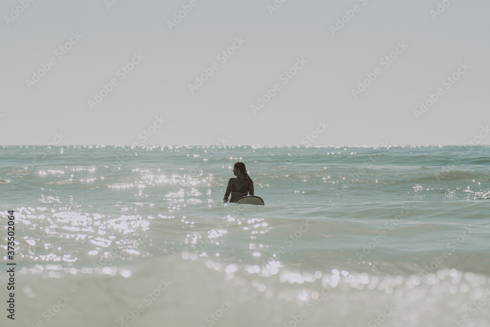 Chica joven y guapa surfeando por playas de Cadiz Stock Photo | Adobe Stock
