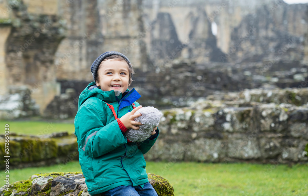 Portrait of School kid taking teddy bear explore with his learning ...