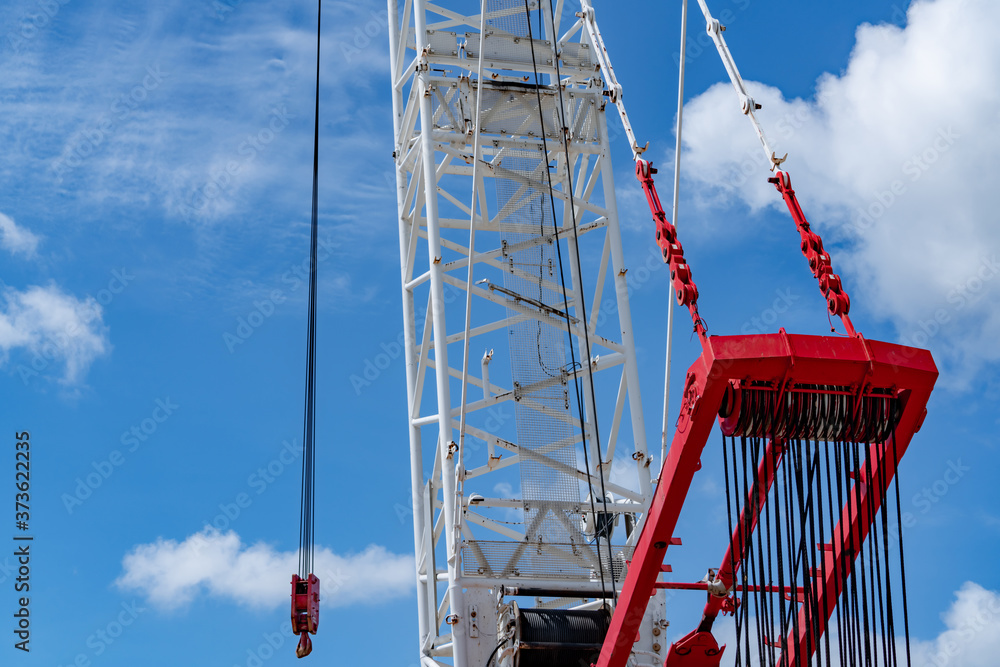 Crawler crane against blue sky and white clouds. Real estate industry ...