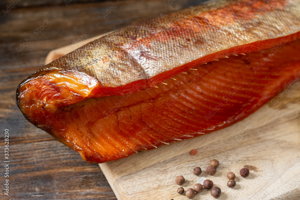 Smoked fish trout. Whole Smoked trout on the serving Board. Smoked ...