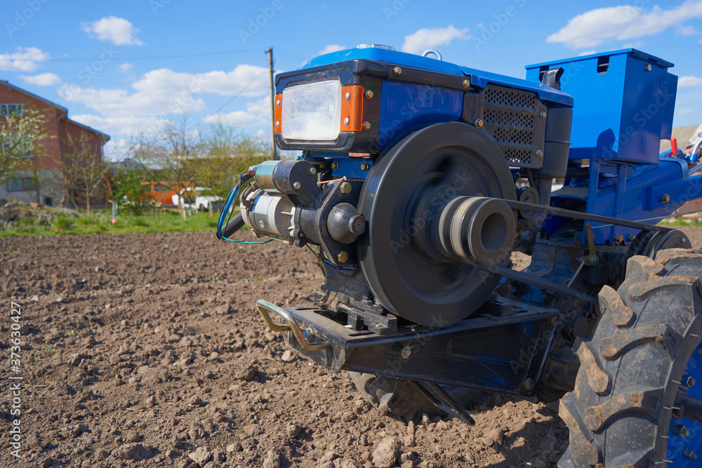 walking-tractor working on the ground,work tractor front in the field ...