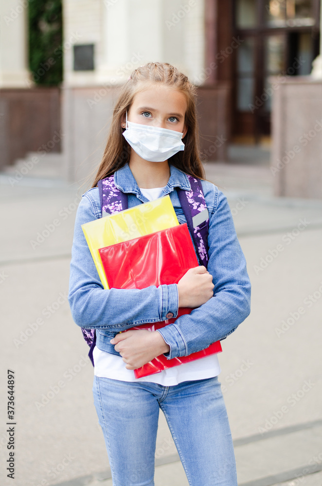 Little girl child with face mask and backpack. Education concept. Back ...