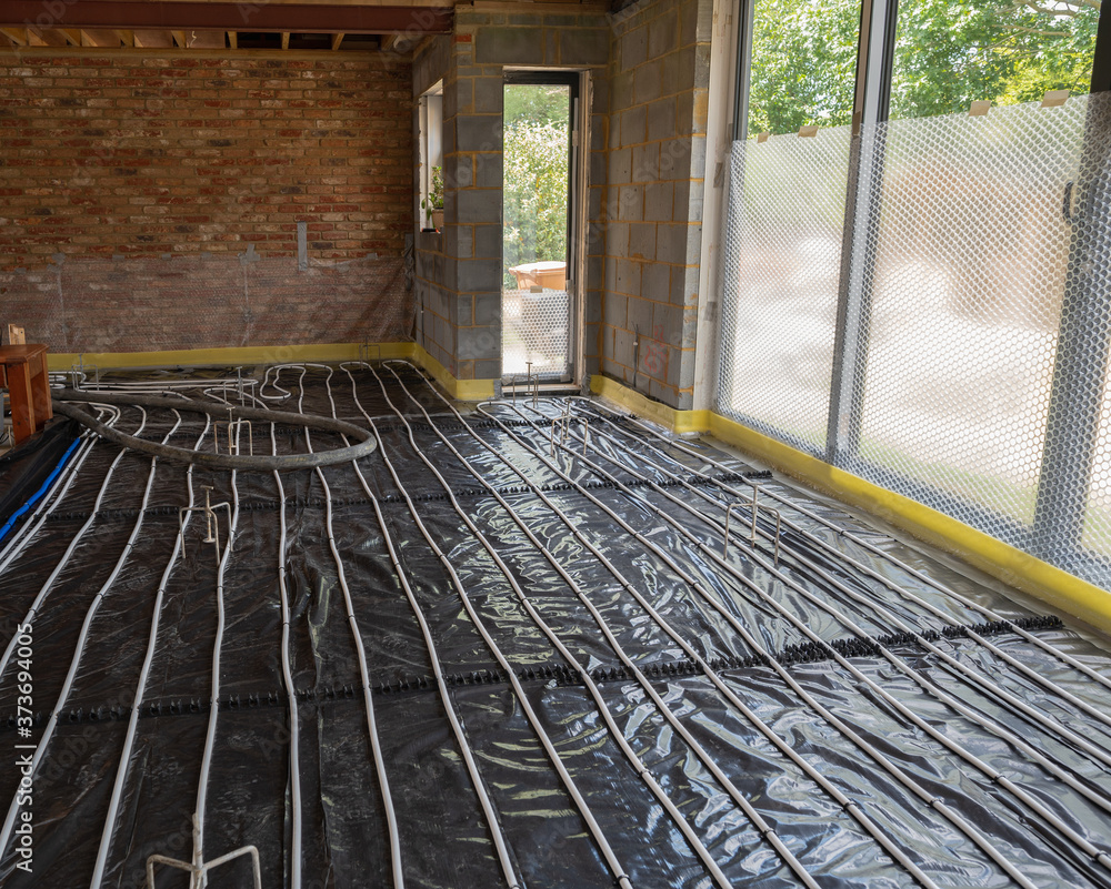 Installation of underfloor heating in the house, layer of plastic over ...