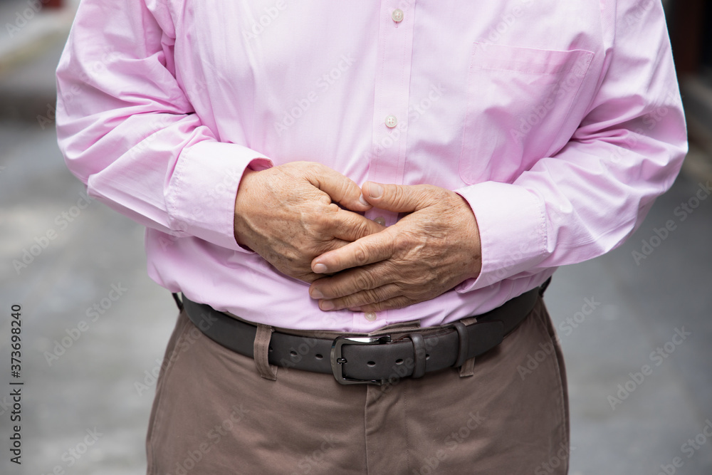 old senior man with stomach ache; retired man suffering from ...