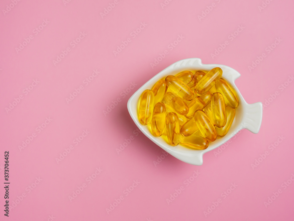 Fish oil capsules with omega 3 and vitamin D in a fish bowl, sport ...