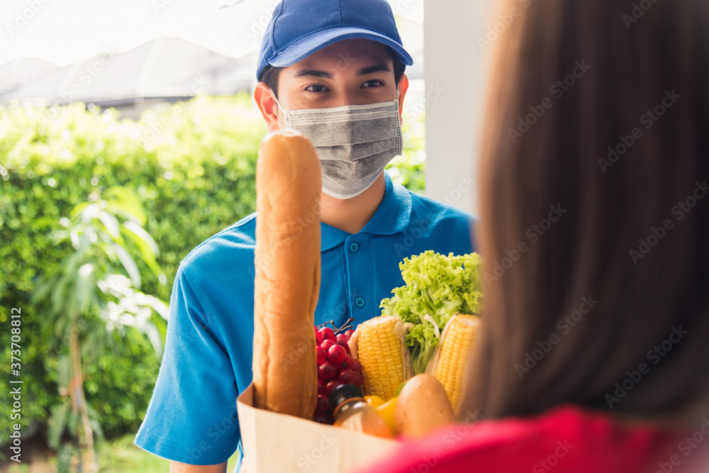 Asian young delivery man in uniform wear protective face mask he making ...