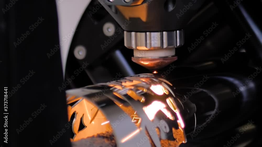 Laser cutting machine working with cylindrical metal workpiece with ...