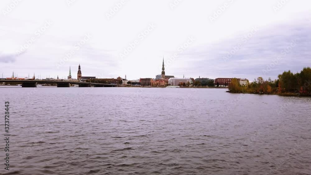 Calm with small ripples water of Dauguva river with Riga's city skyline ...