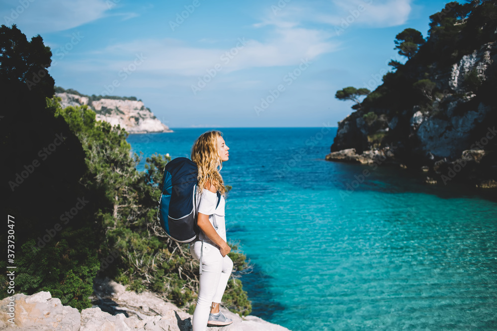 Caucasian female person exploring sunny nature landscape with Mediterranean coast, woman ...