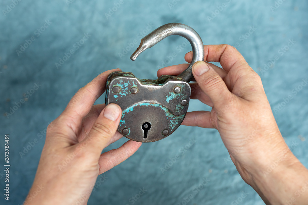 Open old iron lock in women's hands. The concept of liberation from ...