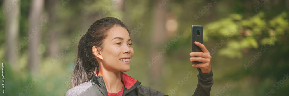 Mobile phone selfie Asian hiker taking photo or video with cellphone in ...
