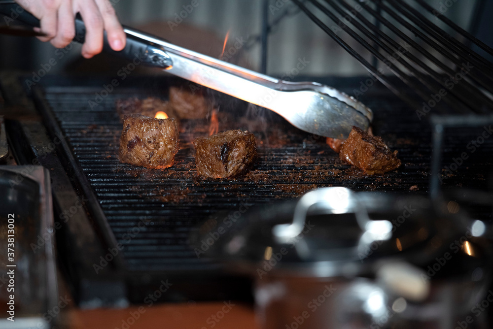Thai chef cooks beef steak in Japanese teppanyaki style. Grilled ...