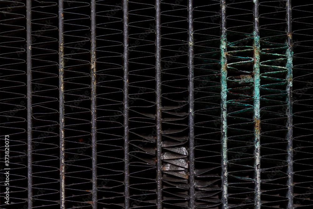 Close up textured and copper fins with group of dry stain green coolant ...