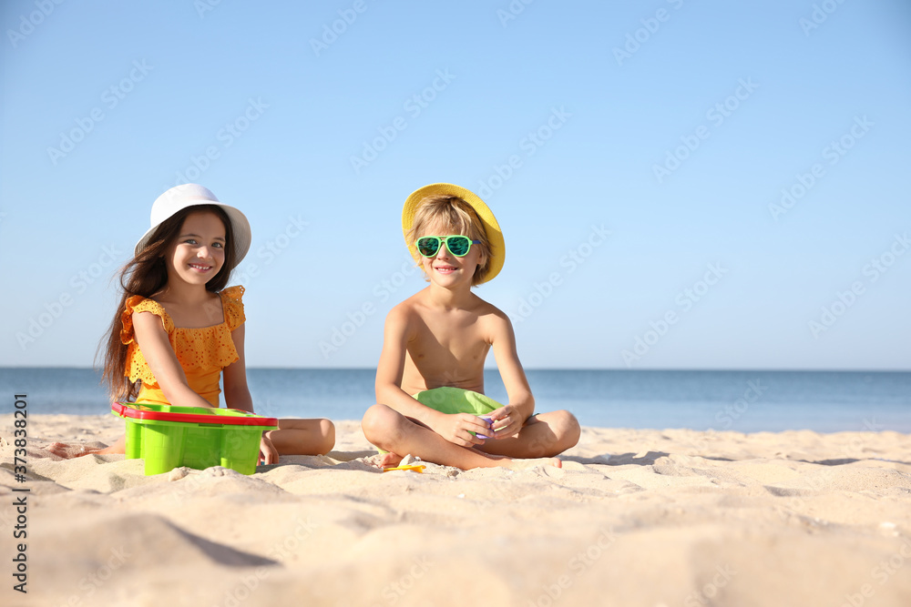 Cute little children playing with plastic toys on sandy beach Stock ...
