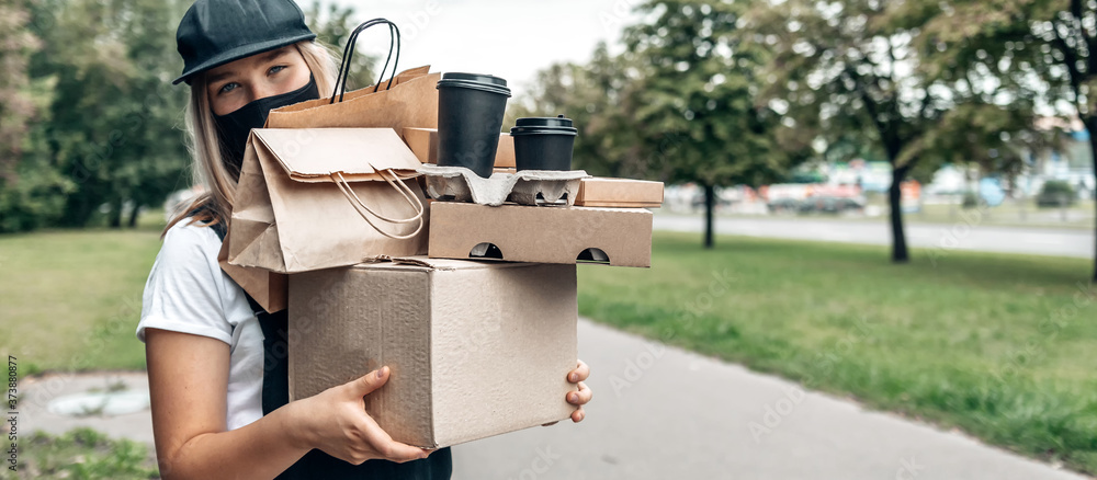 Contactless delivery. Girl Courier with food takeaway zero waste paper ...