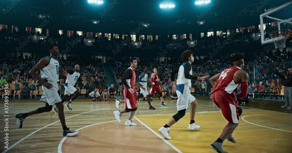Basketball player scores a goal on a professional basketball stadium ...