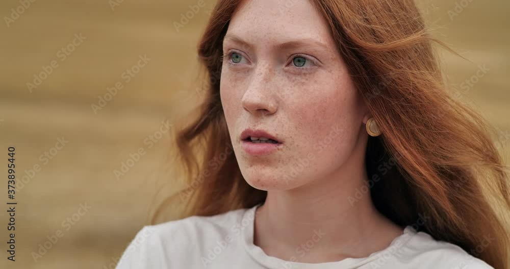 Close Up Portrait of Ginger young Woman opening her Blue Eyes while ...
