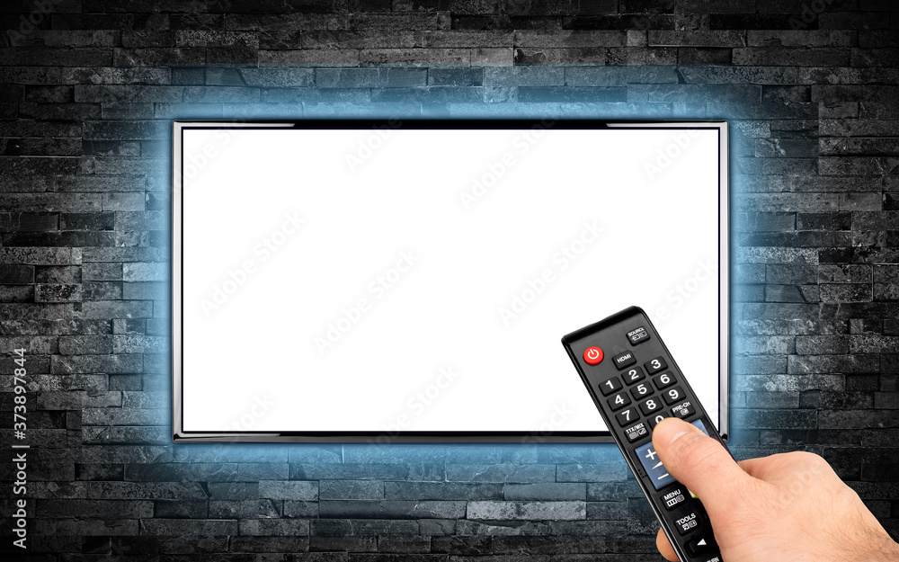 hand with remote on empty black flat tv screen display with copy space ...