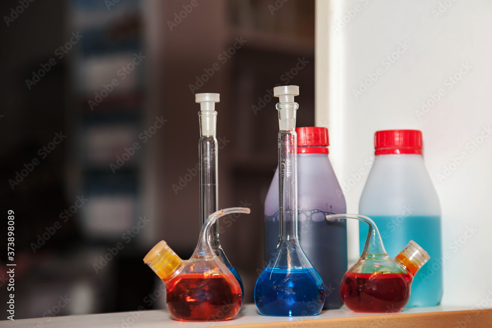 Group of flasks and test tubes in chemical laboratory. Reagents and ...
