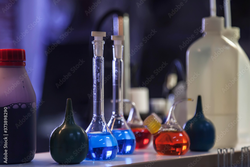 Group of flasks and test tubes in chemical laboratory. Reagents and ...
