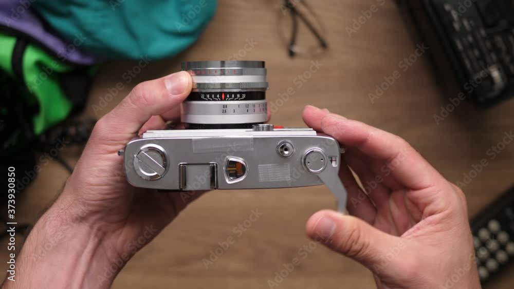 Using a 35mm film camera to take pictures. Top view from above over a ...