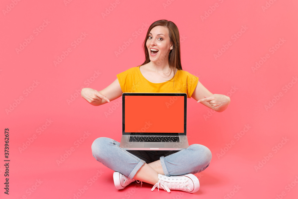 Full length portrait of excited young woman in yellow t-shirt sit on ...