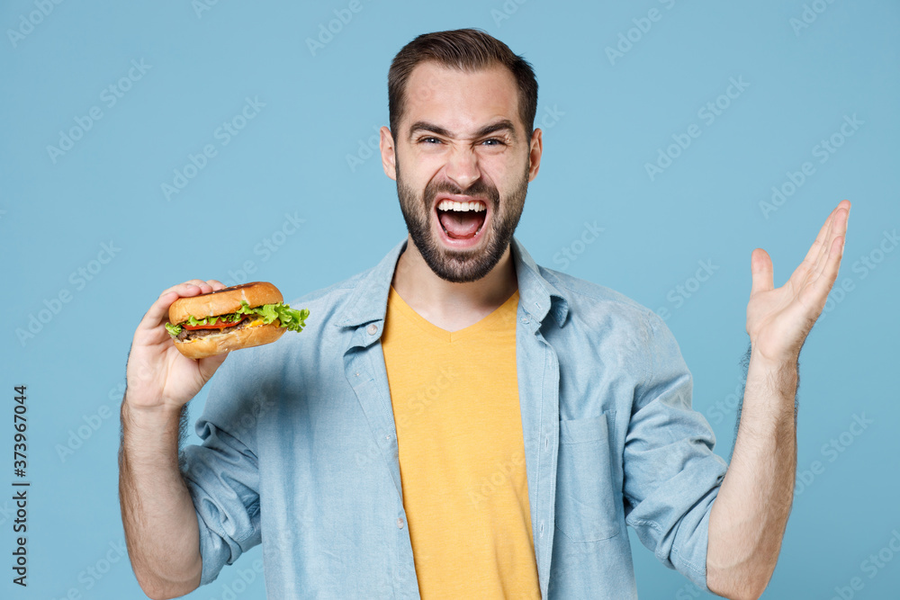 Angry irritated young bearded man guy 20s wearing casual clothes posing ...