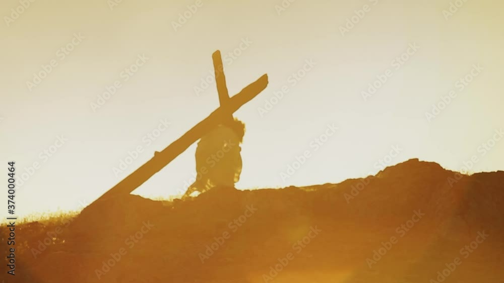 Christ silhouette carrying a heavy Cross - Long Shot Stock Video ...