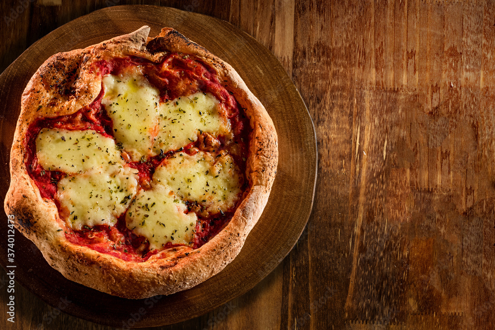 Brazilian pizza with mozzarella cheese, tomato sauce and oregano, on a ...